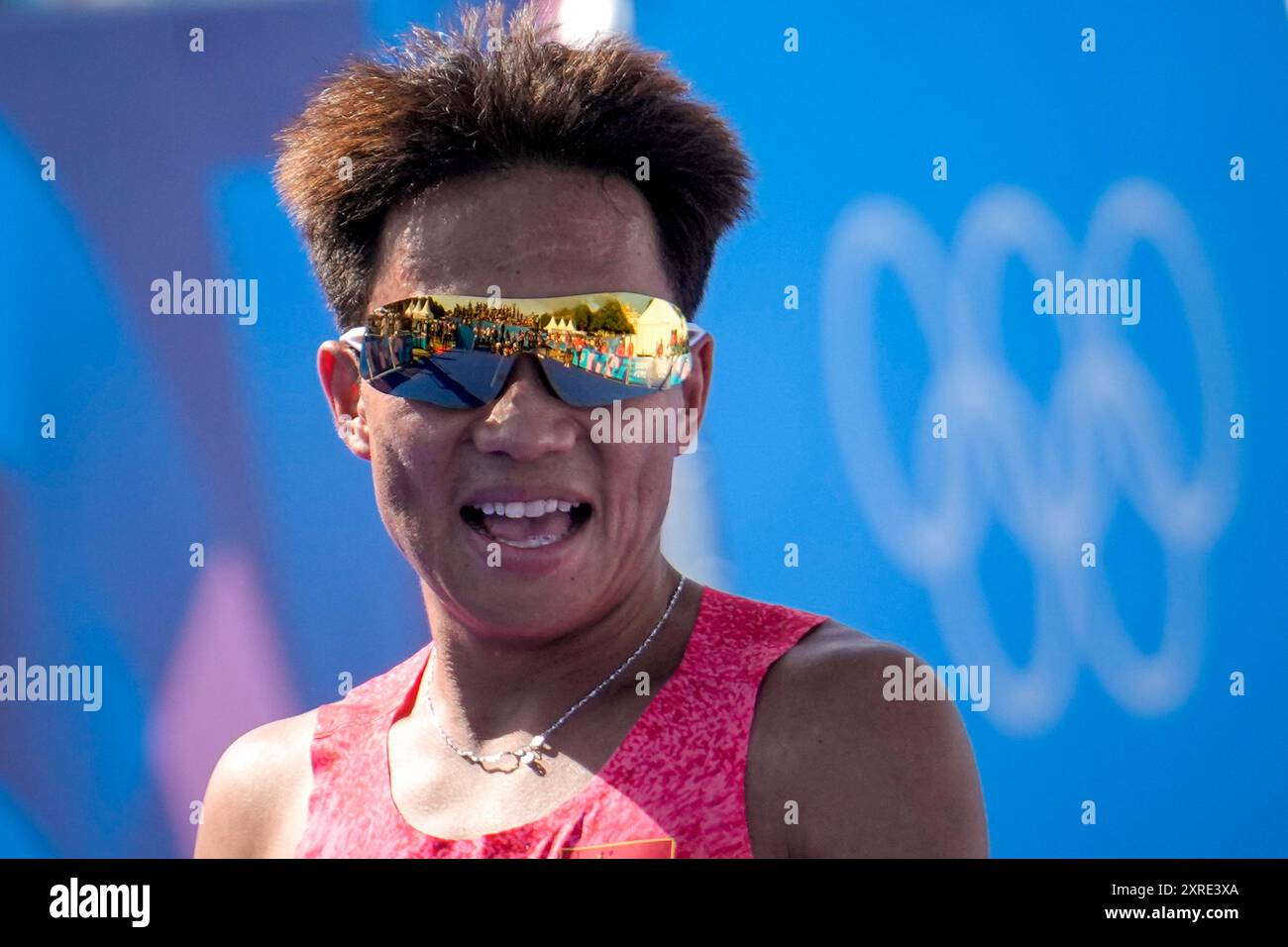 China's He Jie celebrates after crossing the finish line at the end of ...