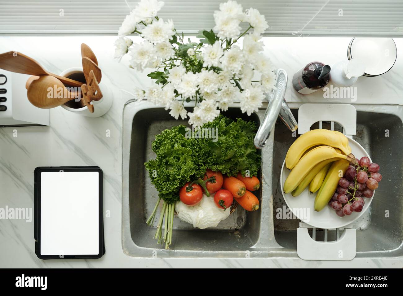 Washing Fruits And Vegetables In The Kitchen Stock Photo - Alamy