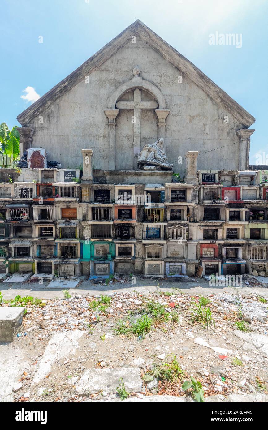 Niches at the back of a cemetery chapel at a cemetery in Cebu City ...
