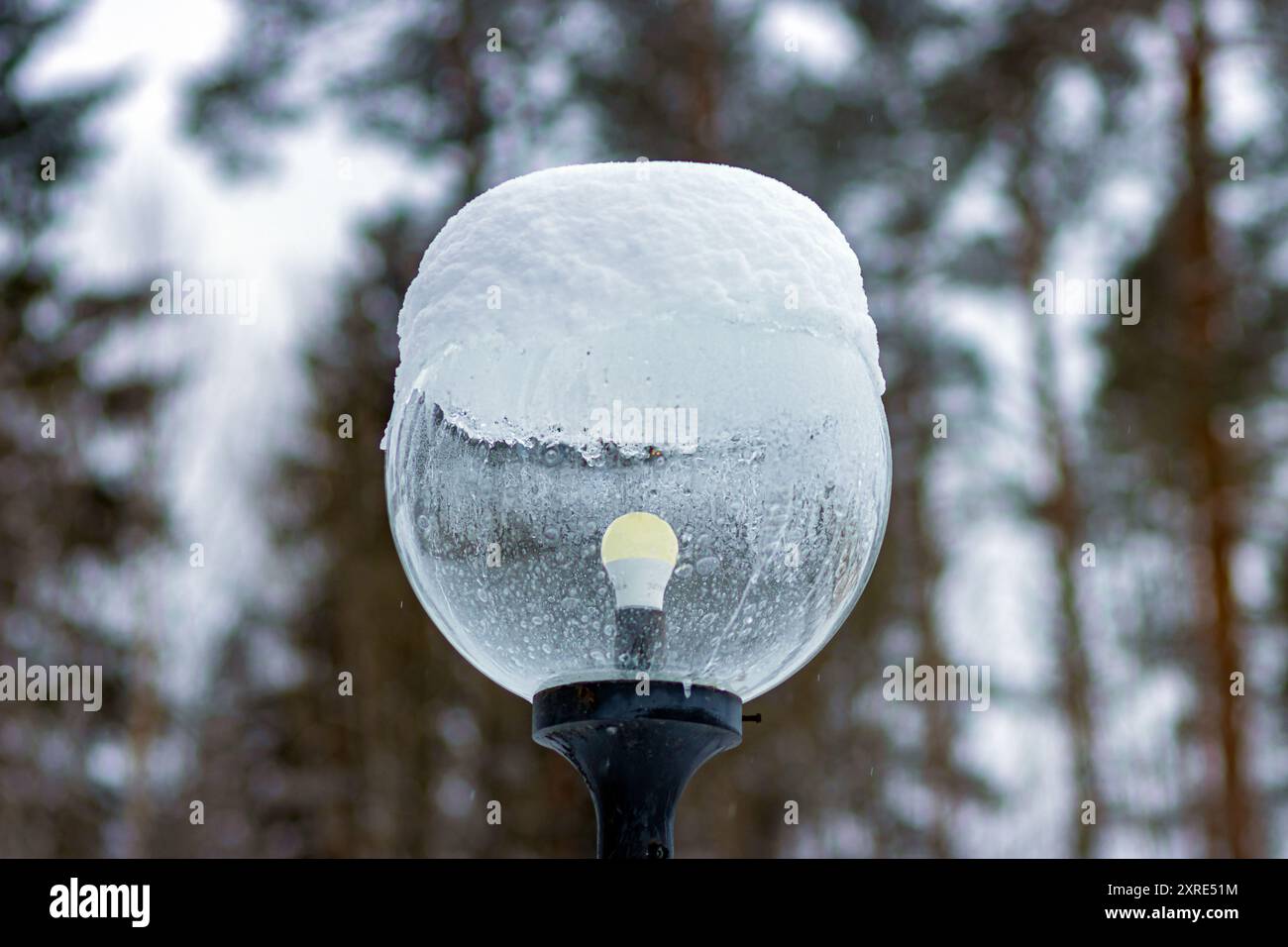 Shining street lamp covered with snow Stock Photo - Alamy