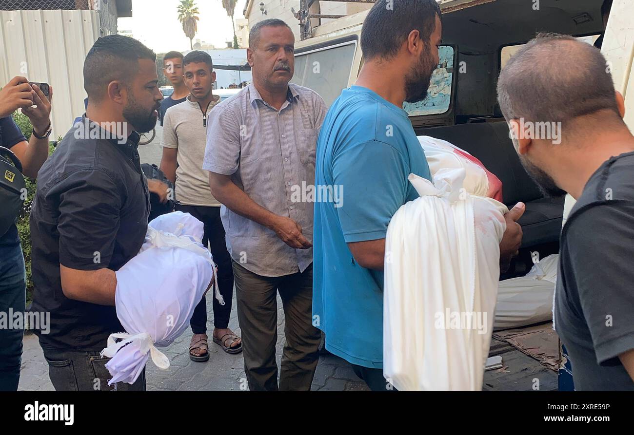 Shrouded bodies are laid down at the al-Maamadani hospital, following ...