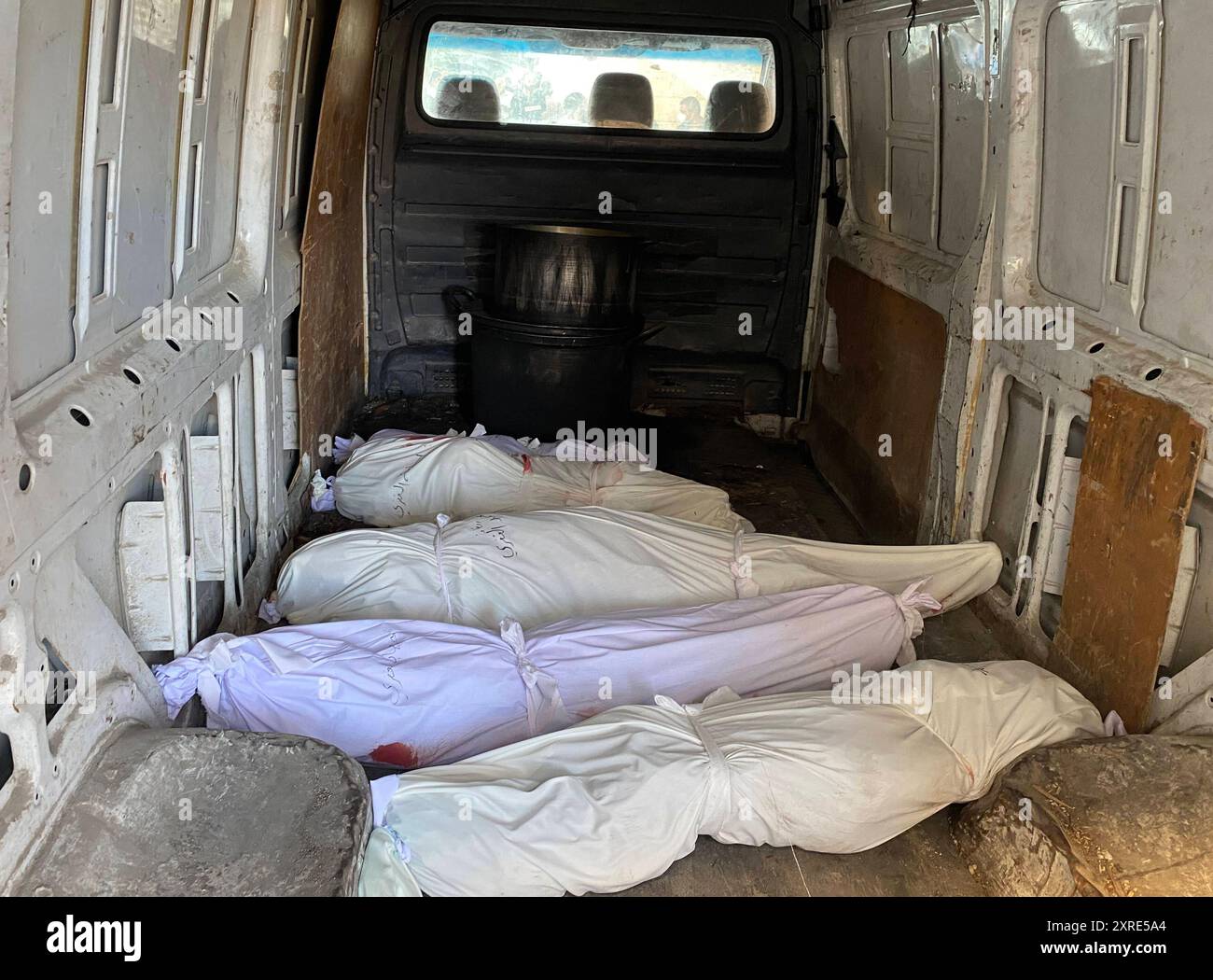 Shrouded bodies are laid down at the al-Maamadani hospital, following ...
