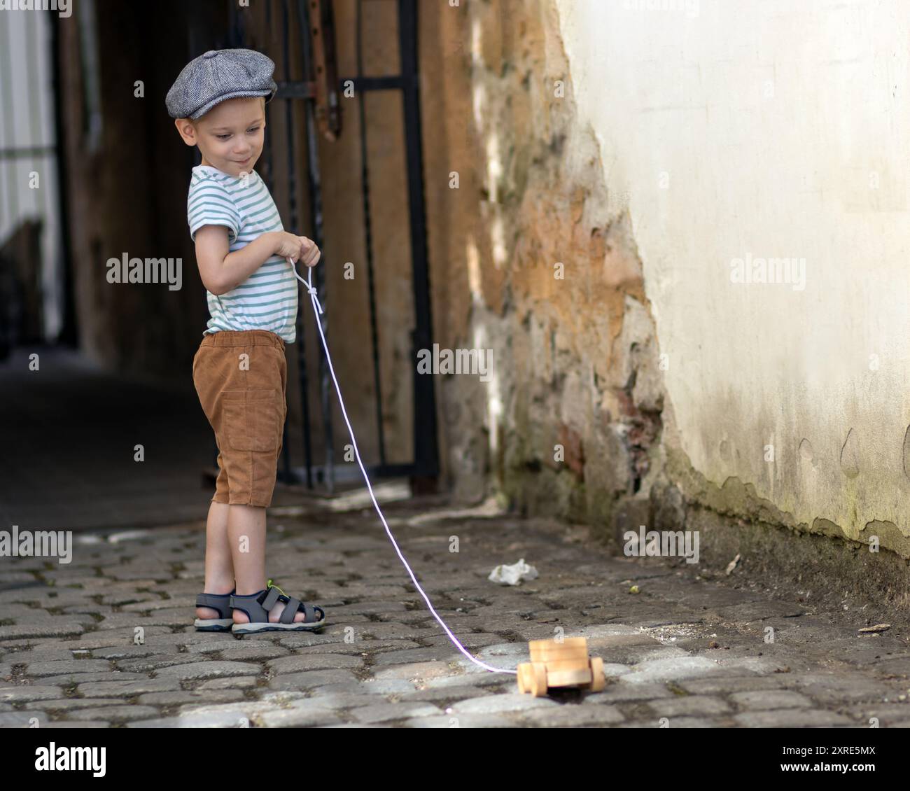 A little boy pulls a wooden cart on the street Stock Photo - Alamy