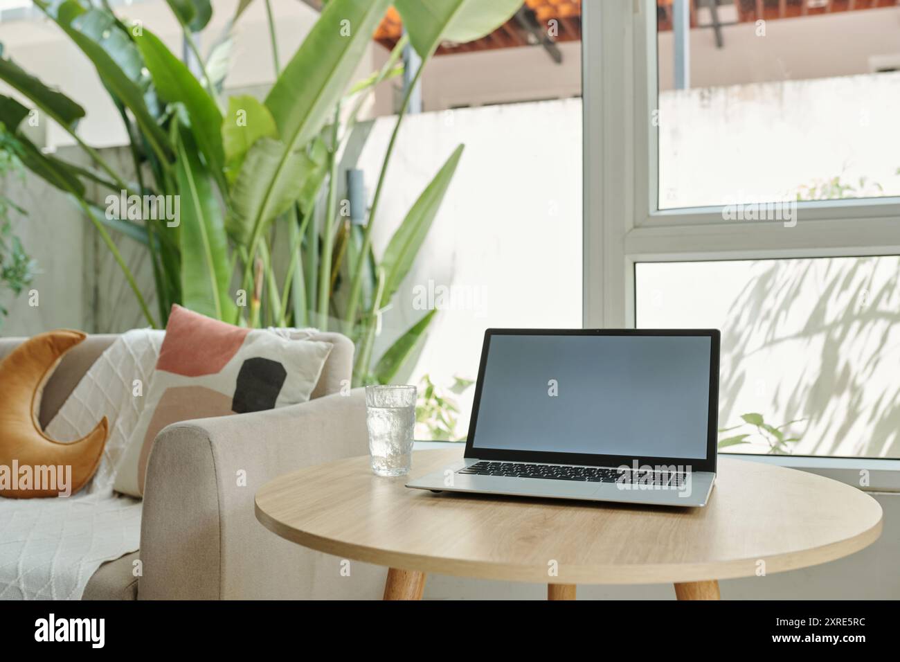 Laptop On Coffee Table In The Living Room Stock Photo - Alamy