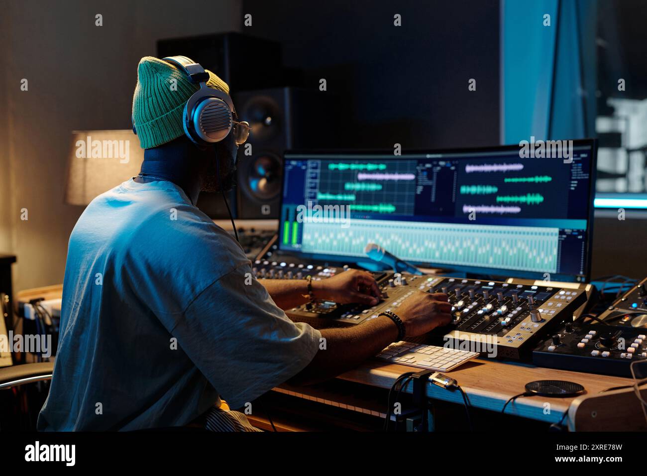 Music producer working on mixing tracks in professional recording ...