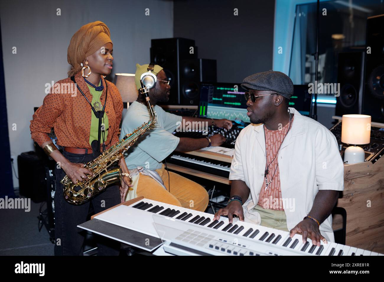 Group of musicians working in recording studio with various instruments ...