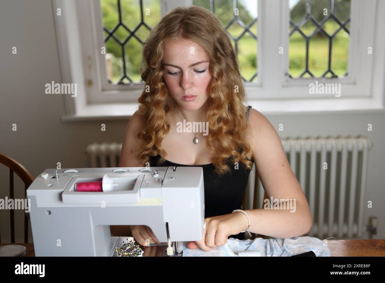 Teenage girl using sewing machine - crafts sewing textiles precision ...