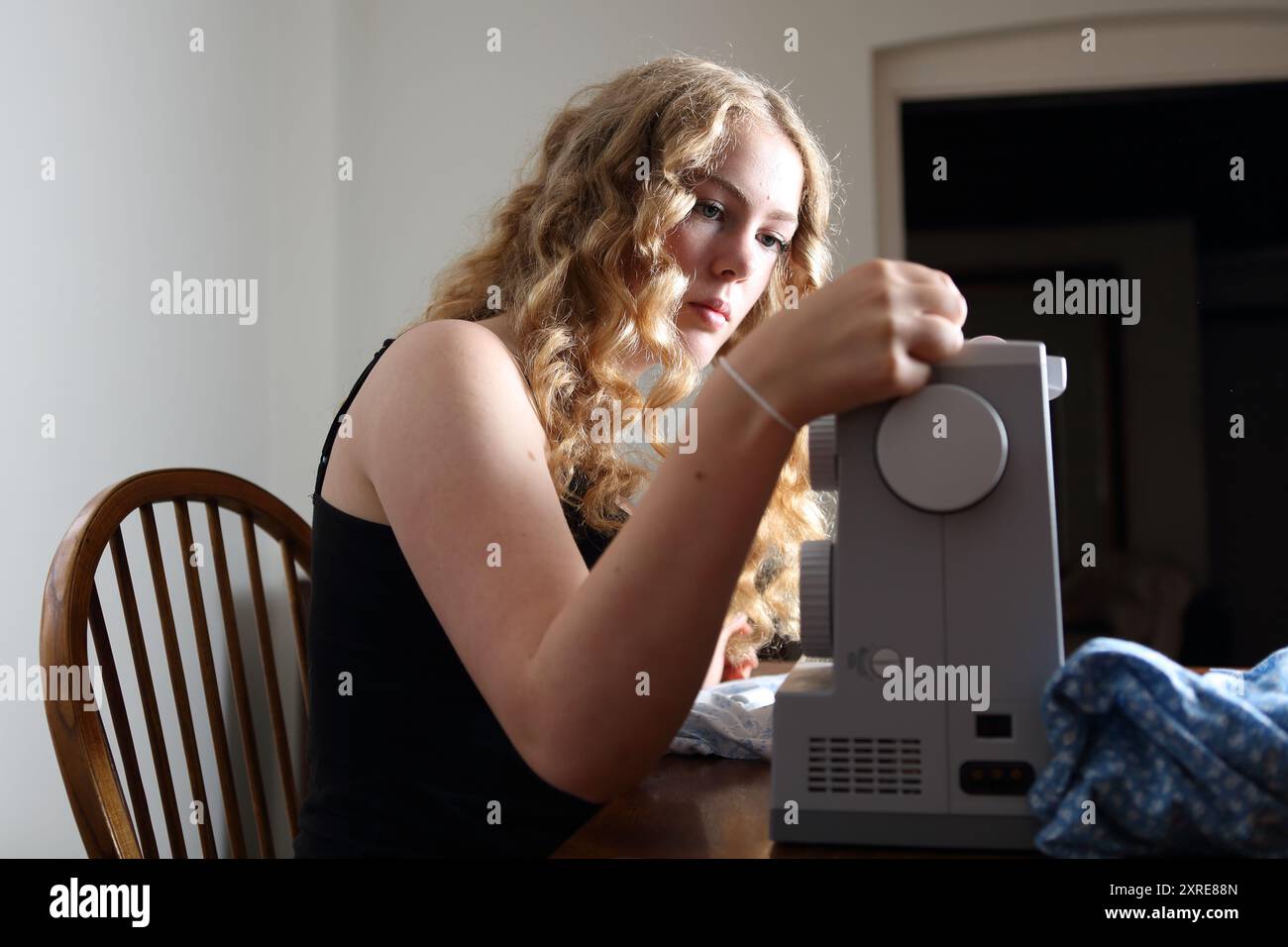 Teenage girl using sewing machine - crafts sewing textiles precision ...