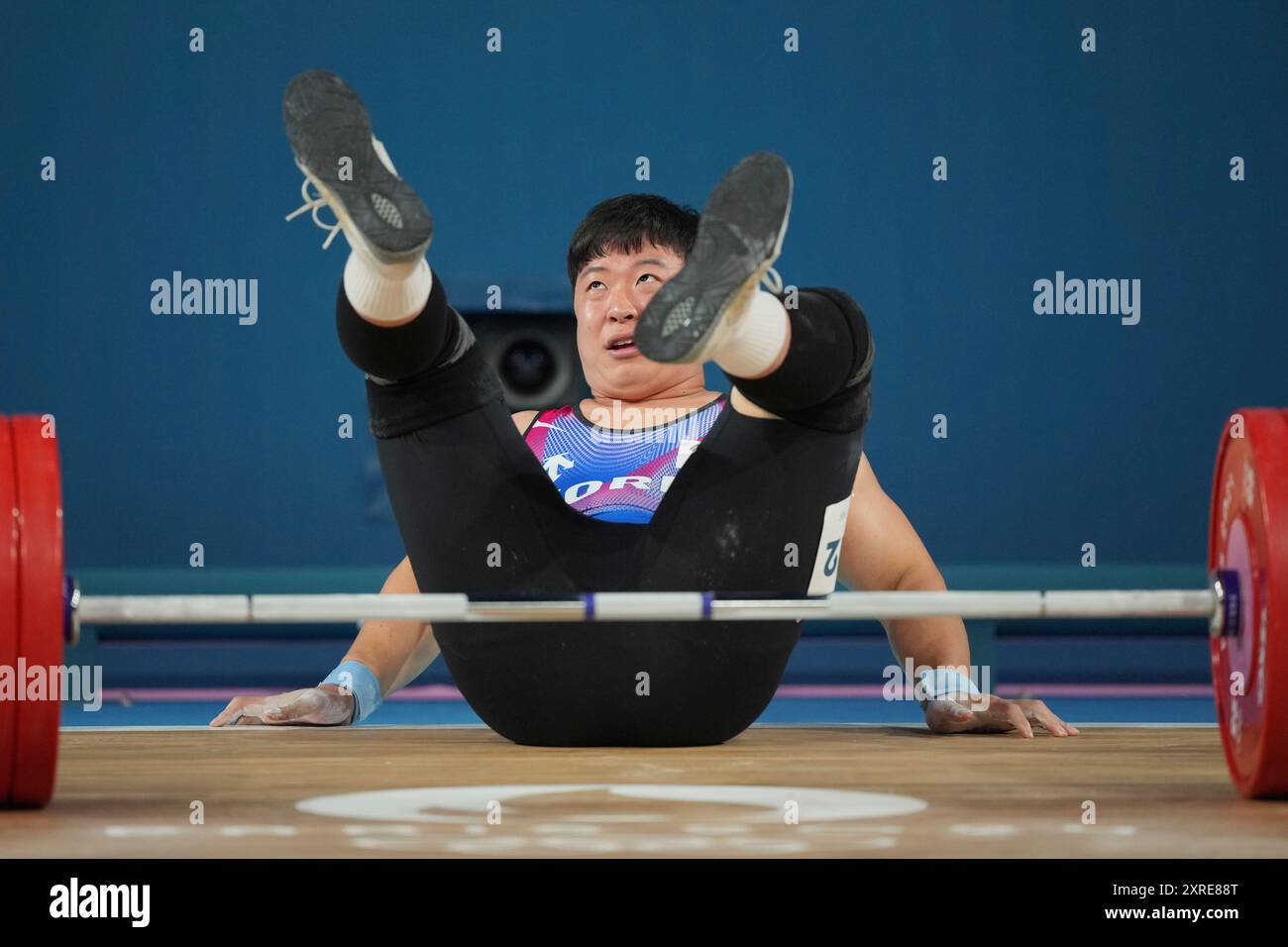 Jang Yeon-hak of South Korea falls as he fails to lift during the men's 102kg weightlifting ...