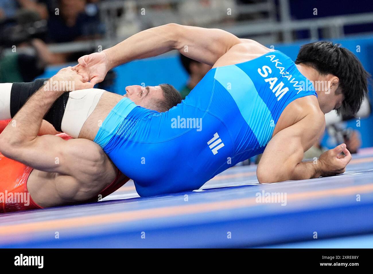 Albania's Islam Dudaev and Samoa's Gaku Akazawa, in blue, compete in ...
