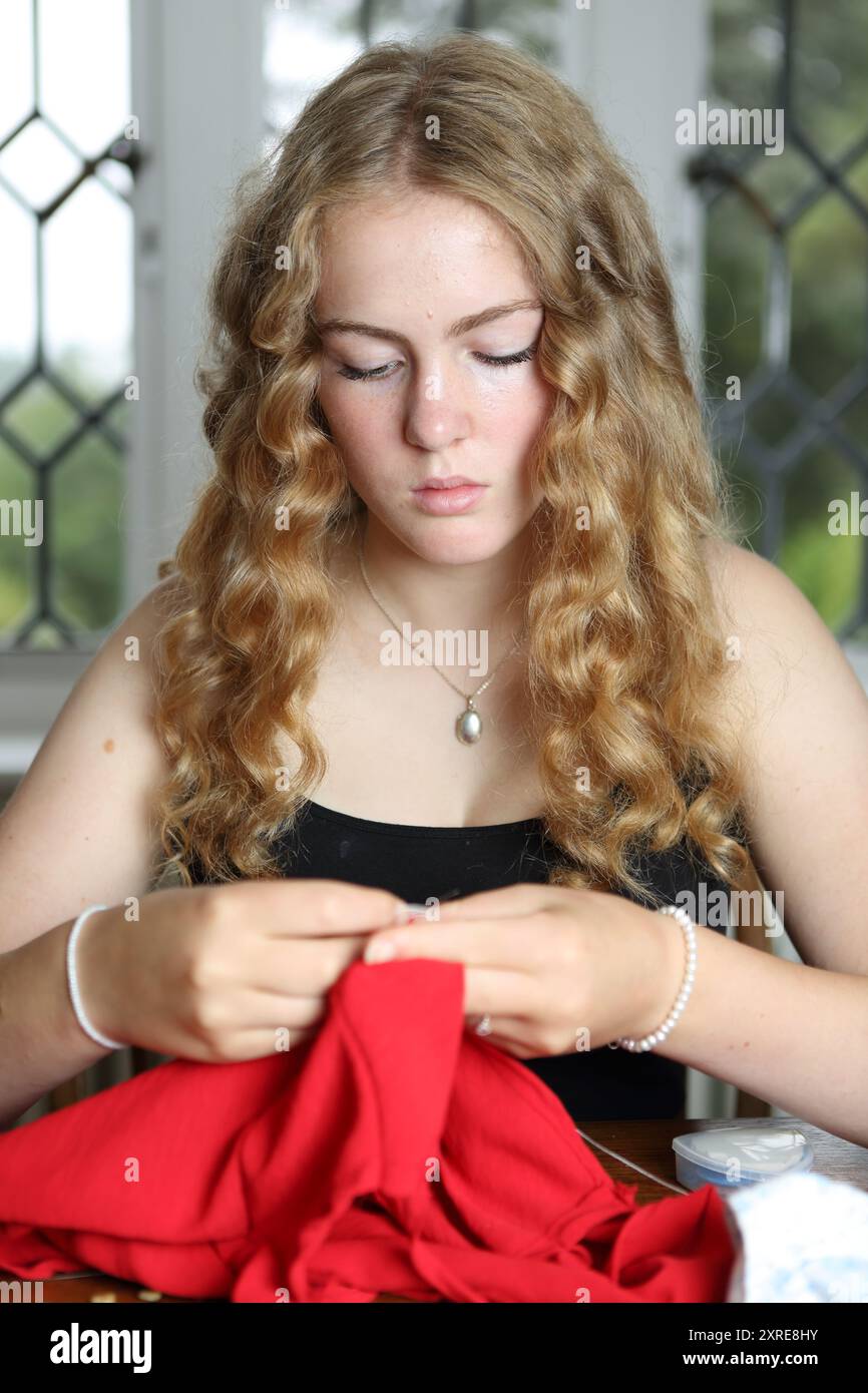Teenage girl hand sewing with needle and thread textiles - craft skills ...