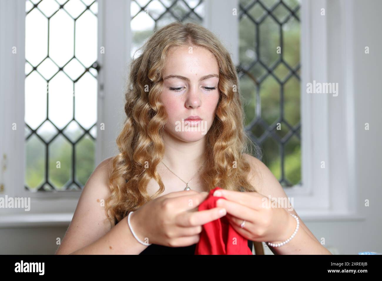 Teenage girl hand sewing with needle and thread textiles - craft skills ...