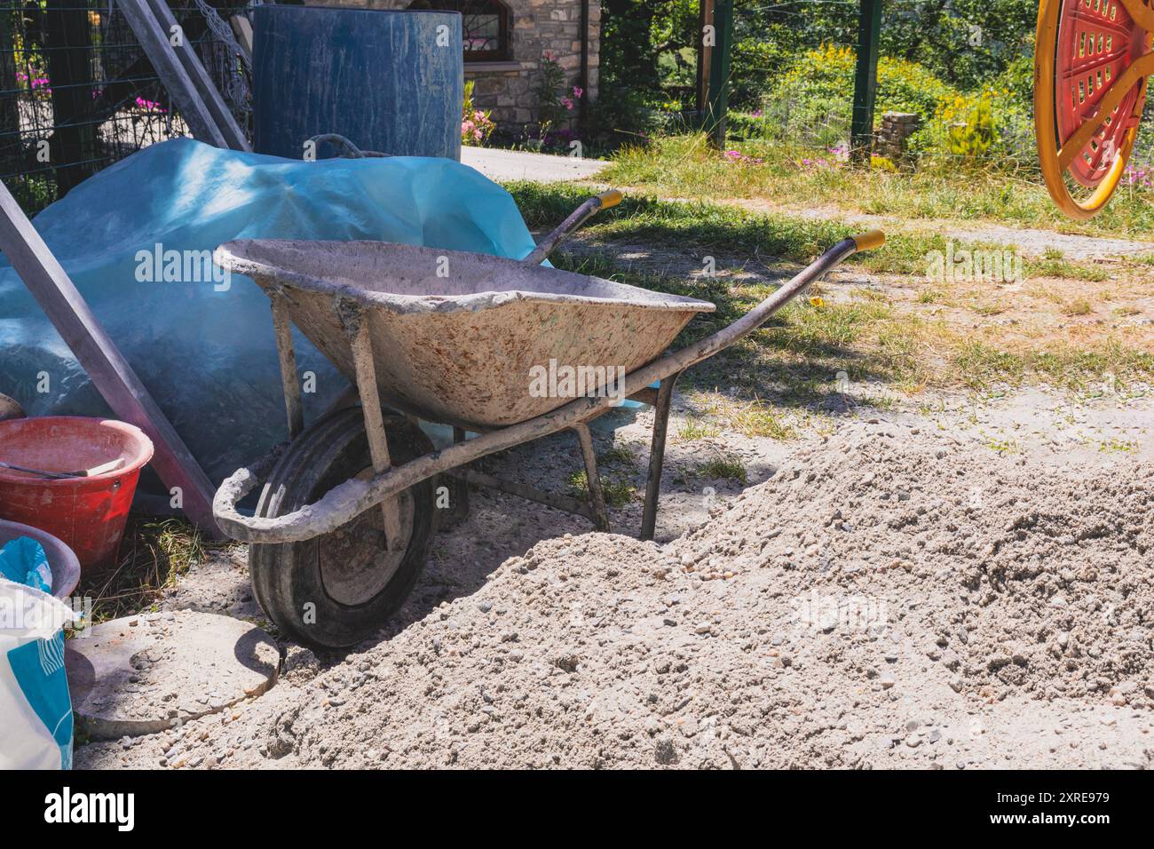 An empty wheelbarrows on a building house demolition site. Copy space ...