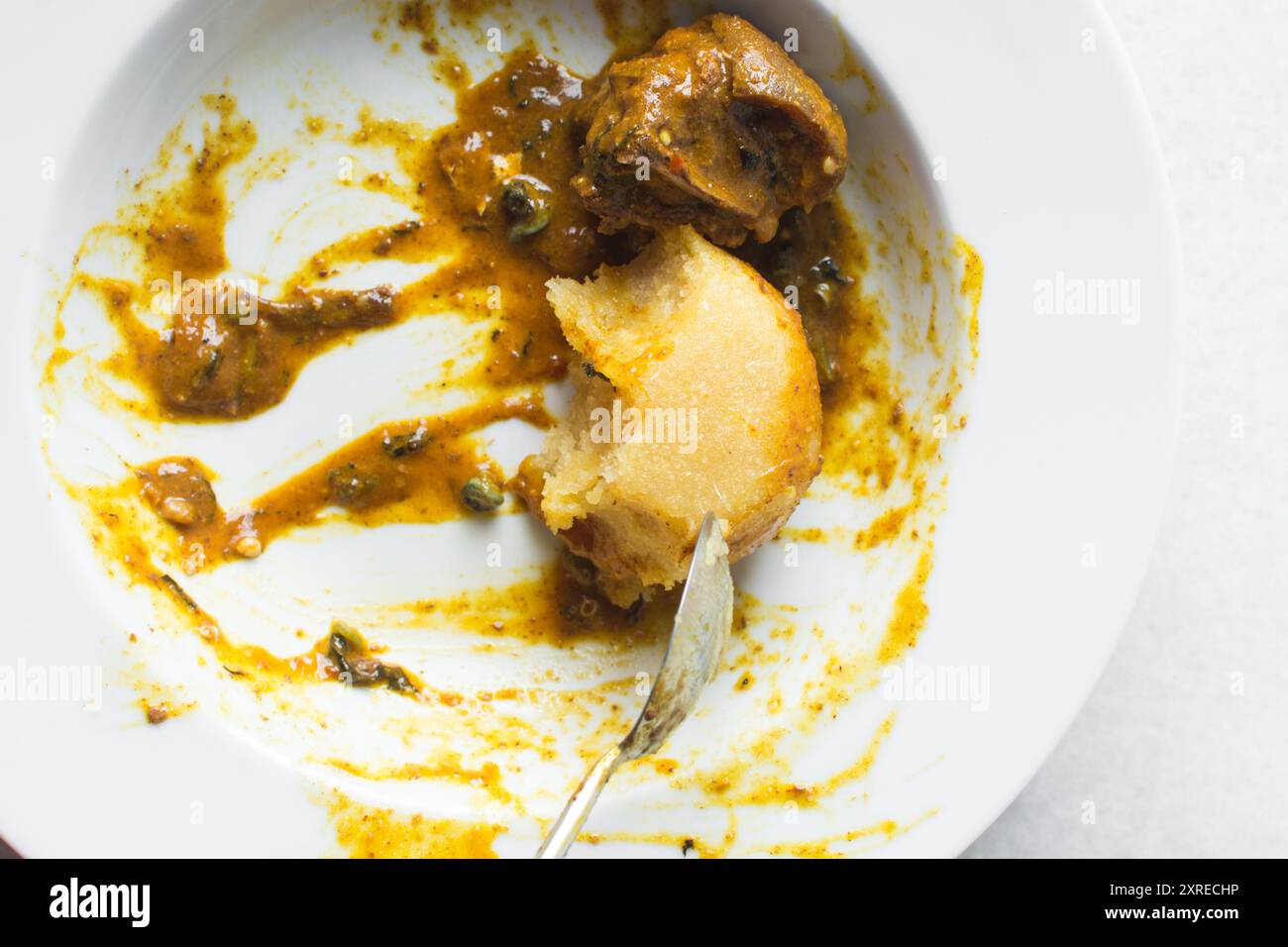 Overhead view of nigerian ogbono soup and eba on a white plate, top ...