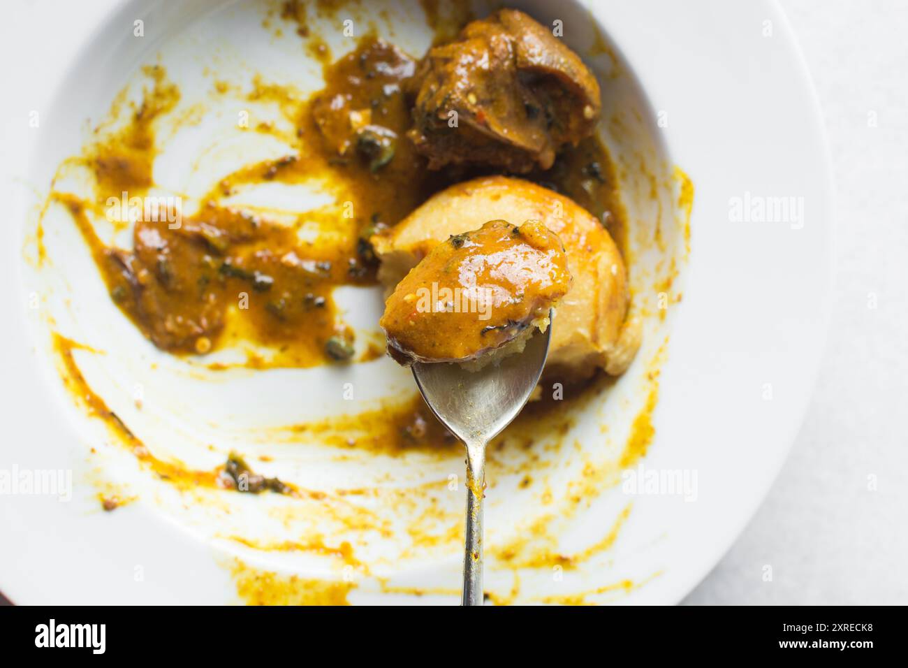 Overhead view of nigerian ogbono soup and eba on a white plate, top ...