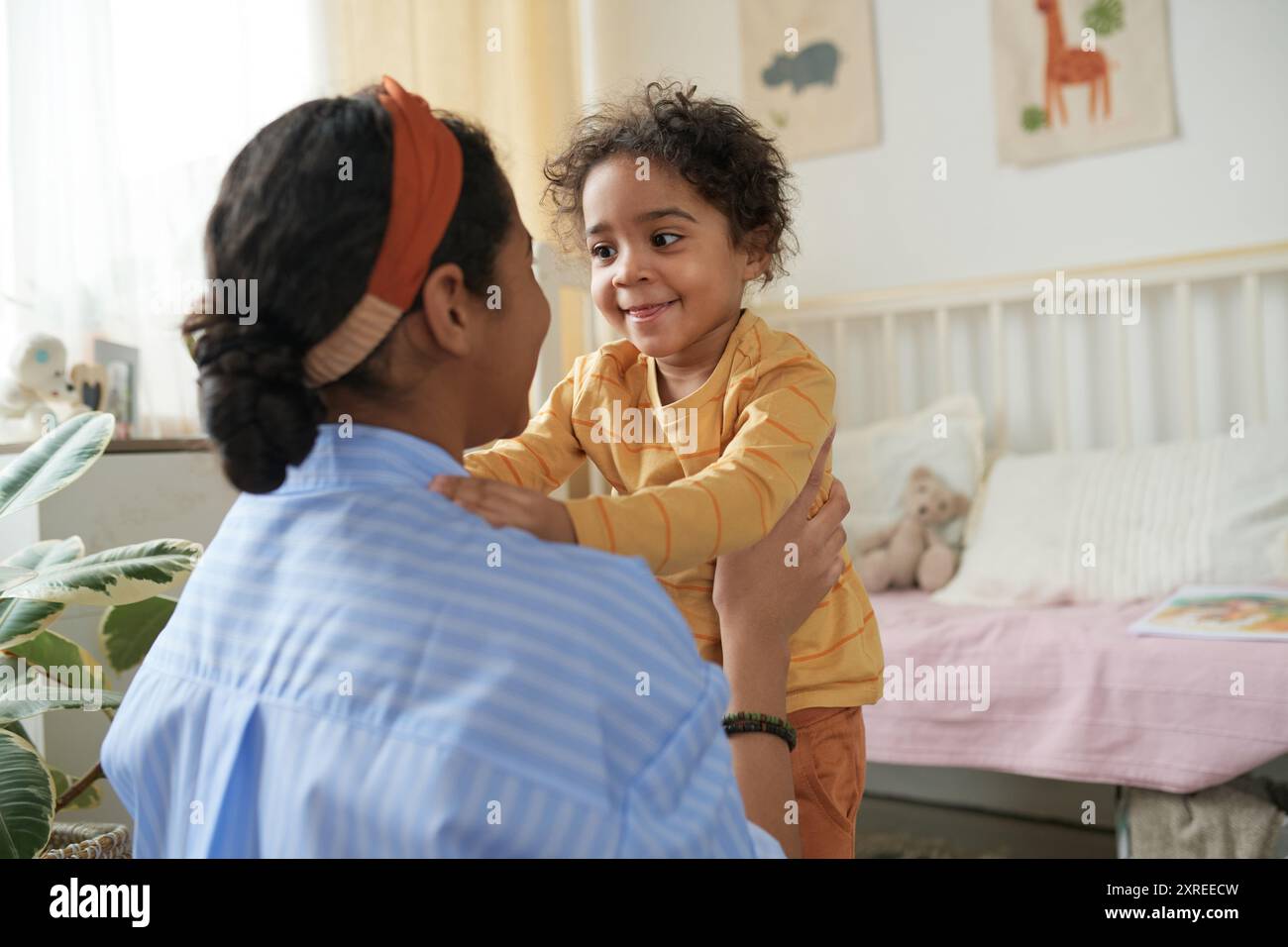 Bonding Moment Between Mother and Child in Nursery Room Stock Photo - Alamy