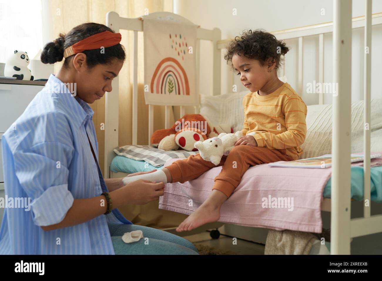 Caring Sister Dressing Kid Stock Photo - Alamy