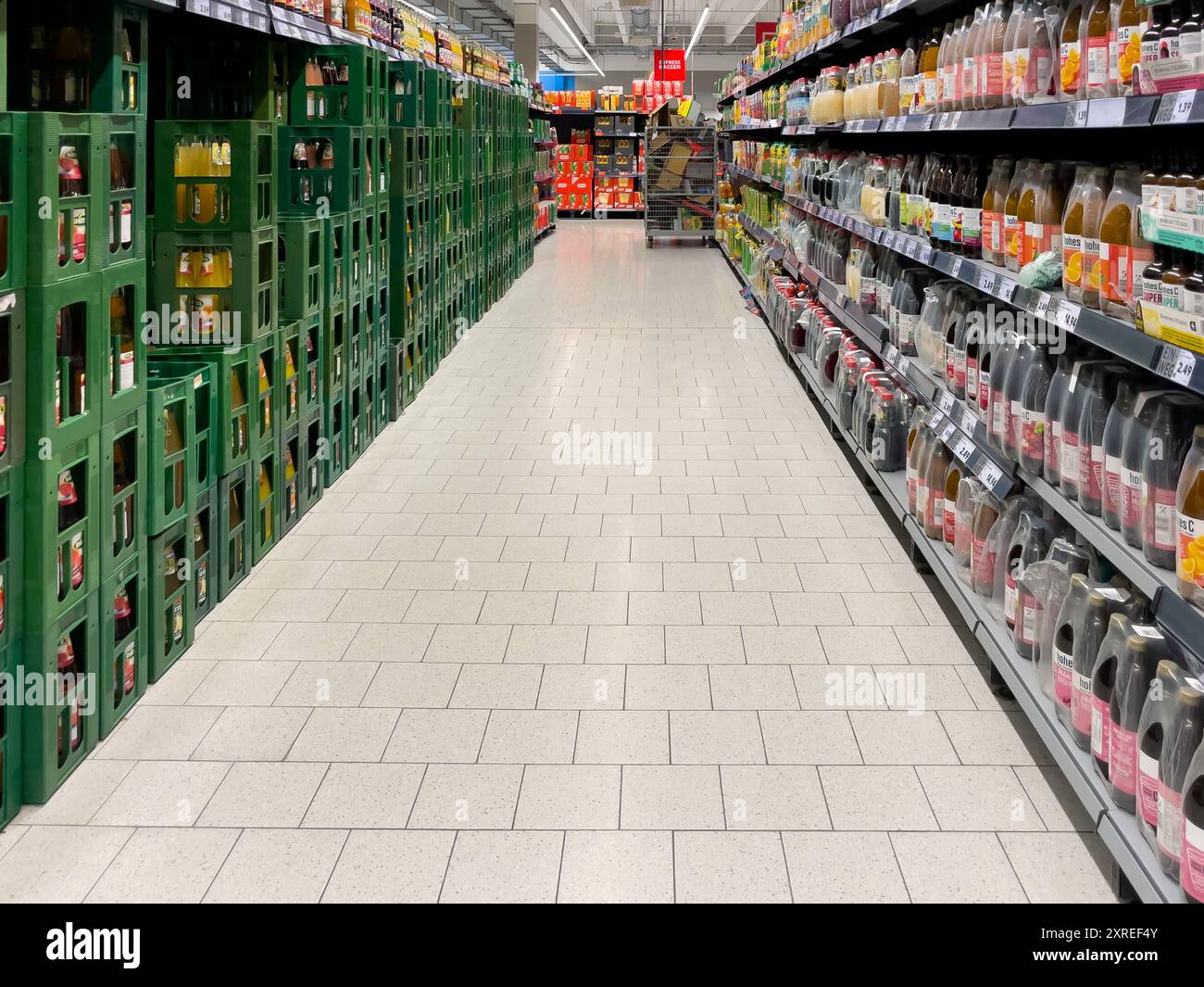 Large store with rows of drinks and other goods. many boxes with ...