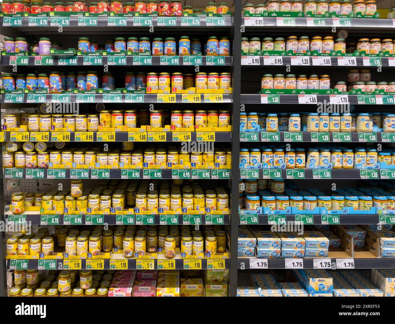 A row of baby food jars on a shelf with a price tag. Supermarket ...