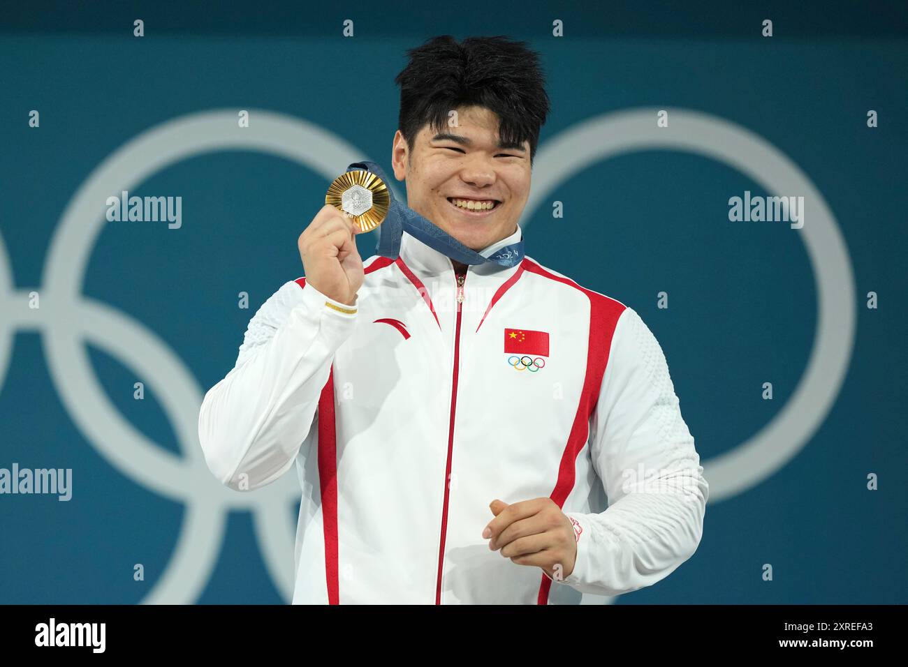 Gold medalist Liu Huanhua of China celebrates on the podium during the ...