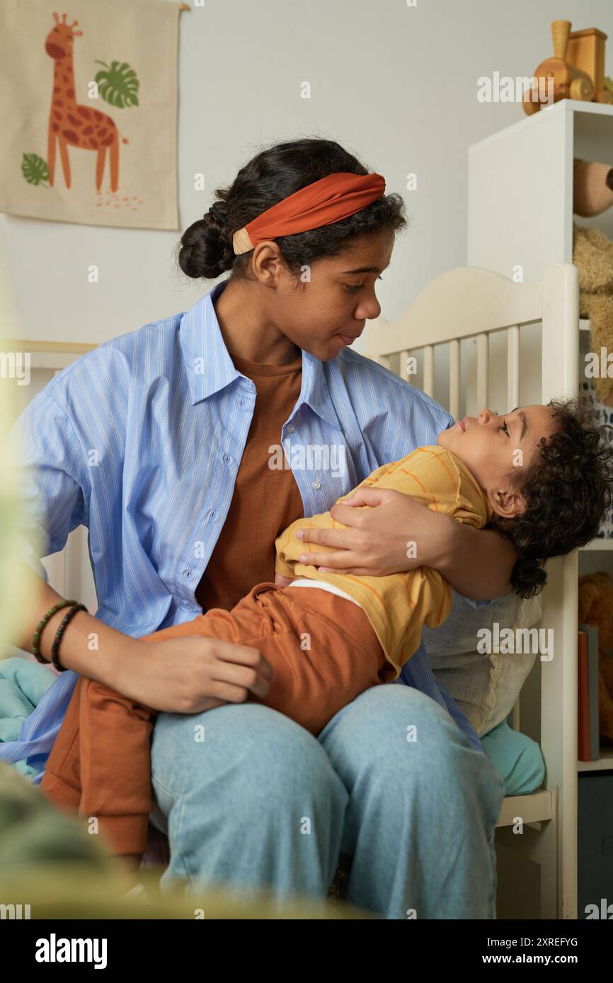 Nurturing Mother Comforting Child in Cozy Bedroom Stock Photo - Alamy