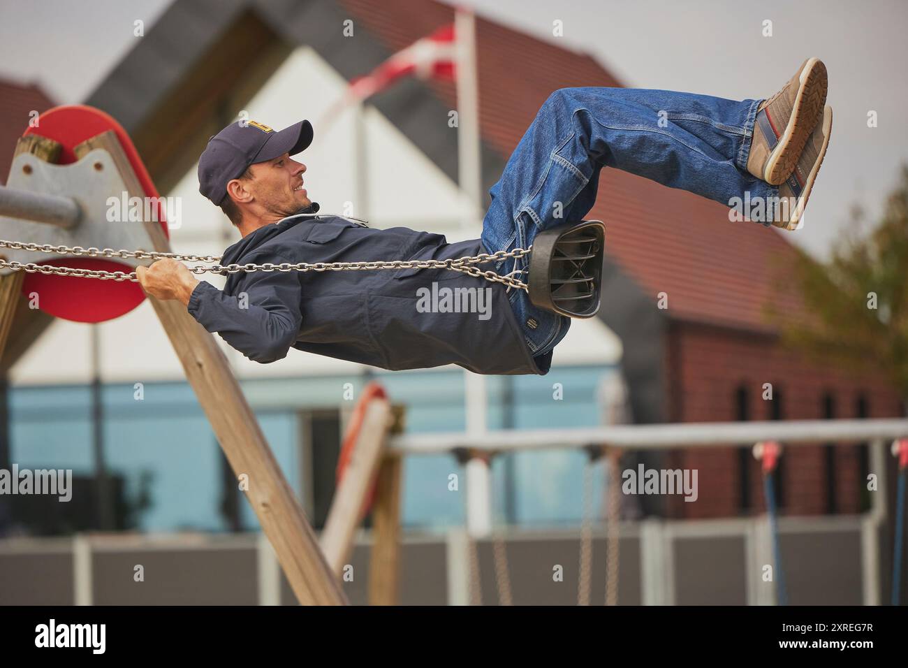 Ringkobing, Denmark, July 2, 2024: Man swinging on a swing Stock Photo ...