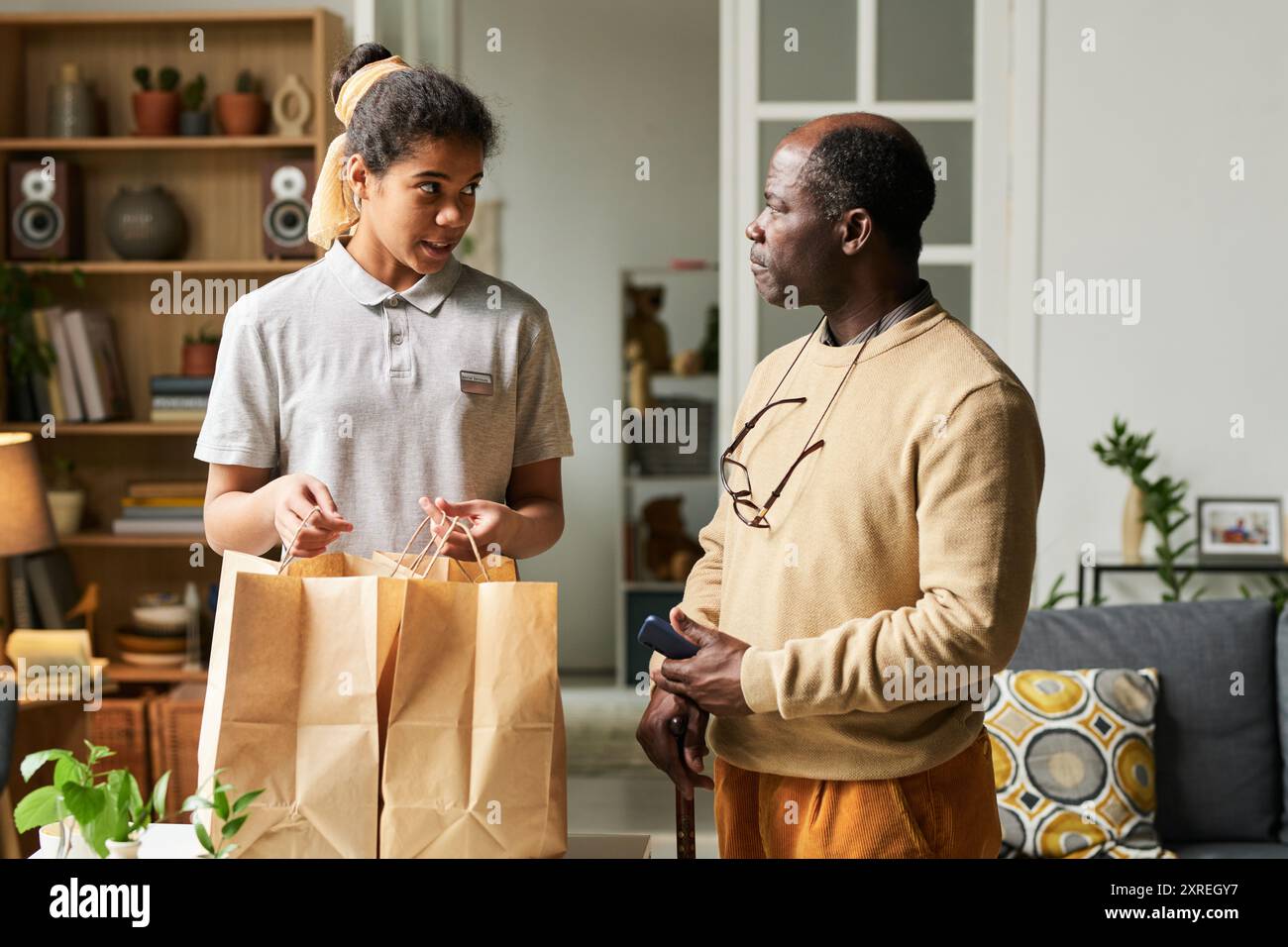 Helping Elderly Man with Grocery Carrying Bags Inside Stock Photo - Alamy