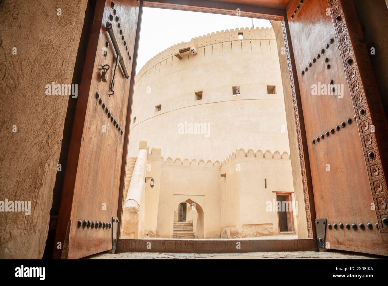 View through the decorated wooden doors to arabic citadel fortress ...