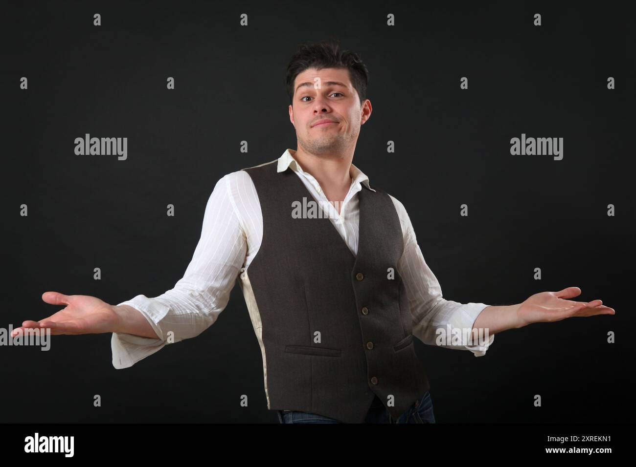 portrait of a handsome man with open arms on black background Stock ...