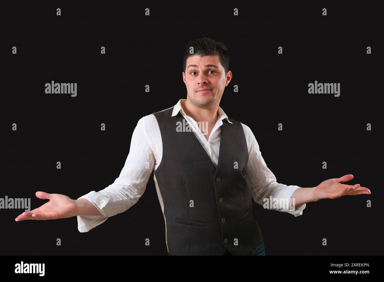 portrait of a handsome man with open arms on black background Stock ...