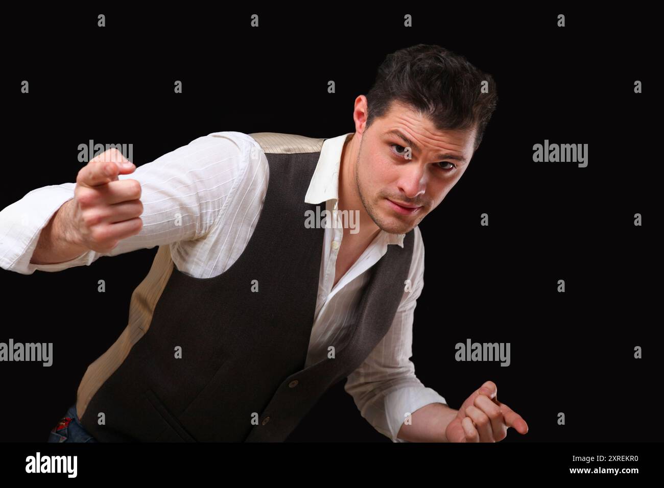 portrait of a young man pointing finger on the black background Stock ...
