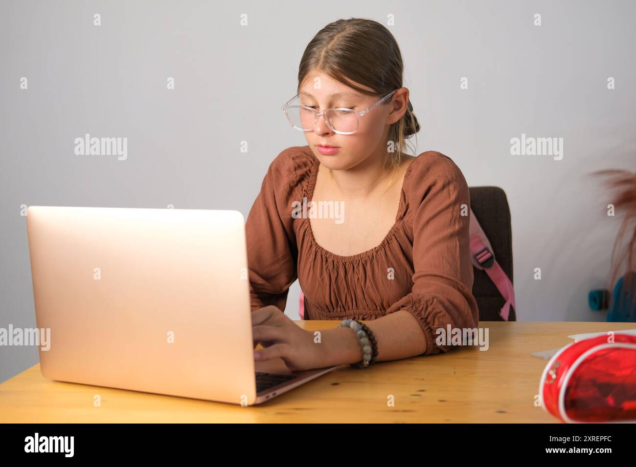 Back to school. Homework. Teen girl with glasses in distance learning ...