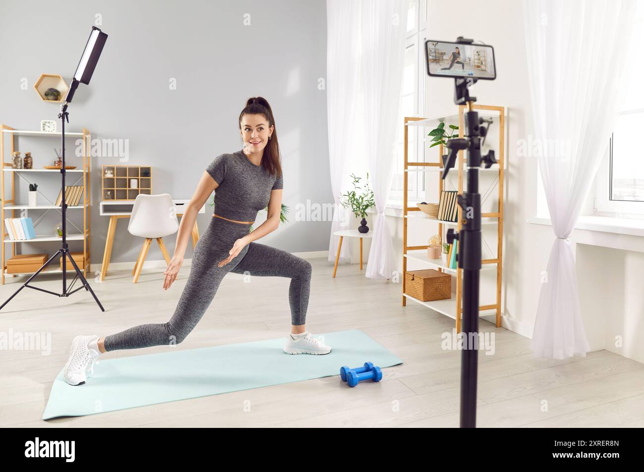 Fitness blogger, fit female sport influencer making video at home to ...