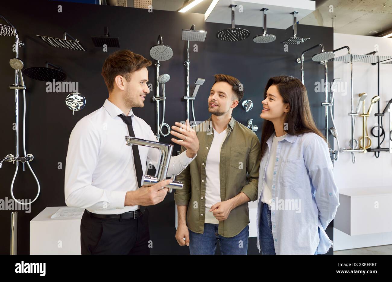 Retail employee helping client choose hi-res stock photography and ...