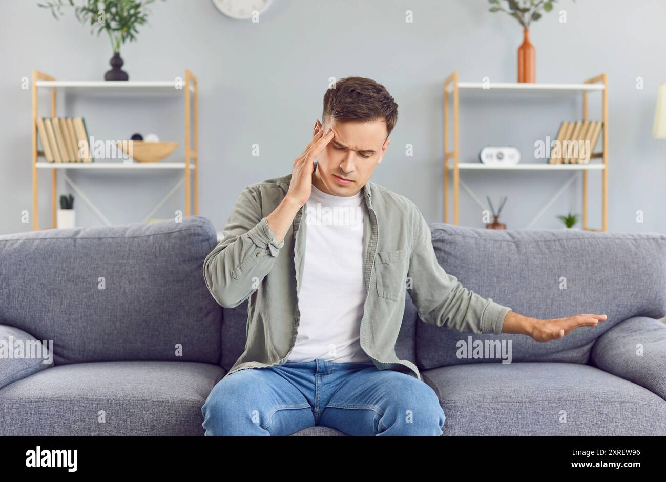 Portrait of stressed man suffering from headache or dizziness, worrying ...