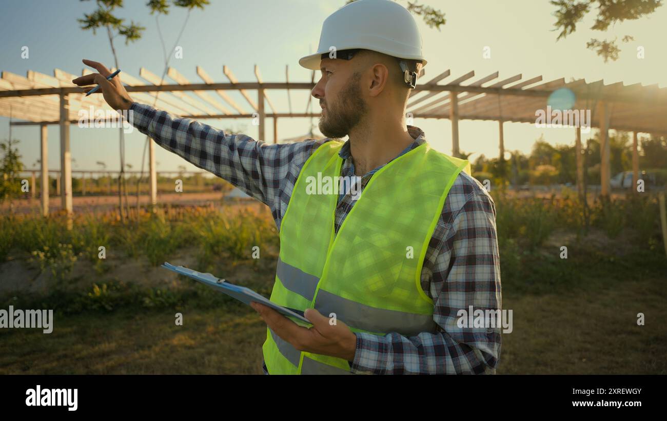 Focused Caucasian man businessman architect male guy engineer hardhat ...