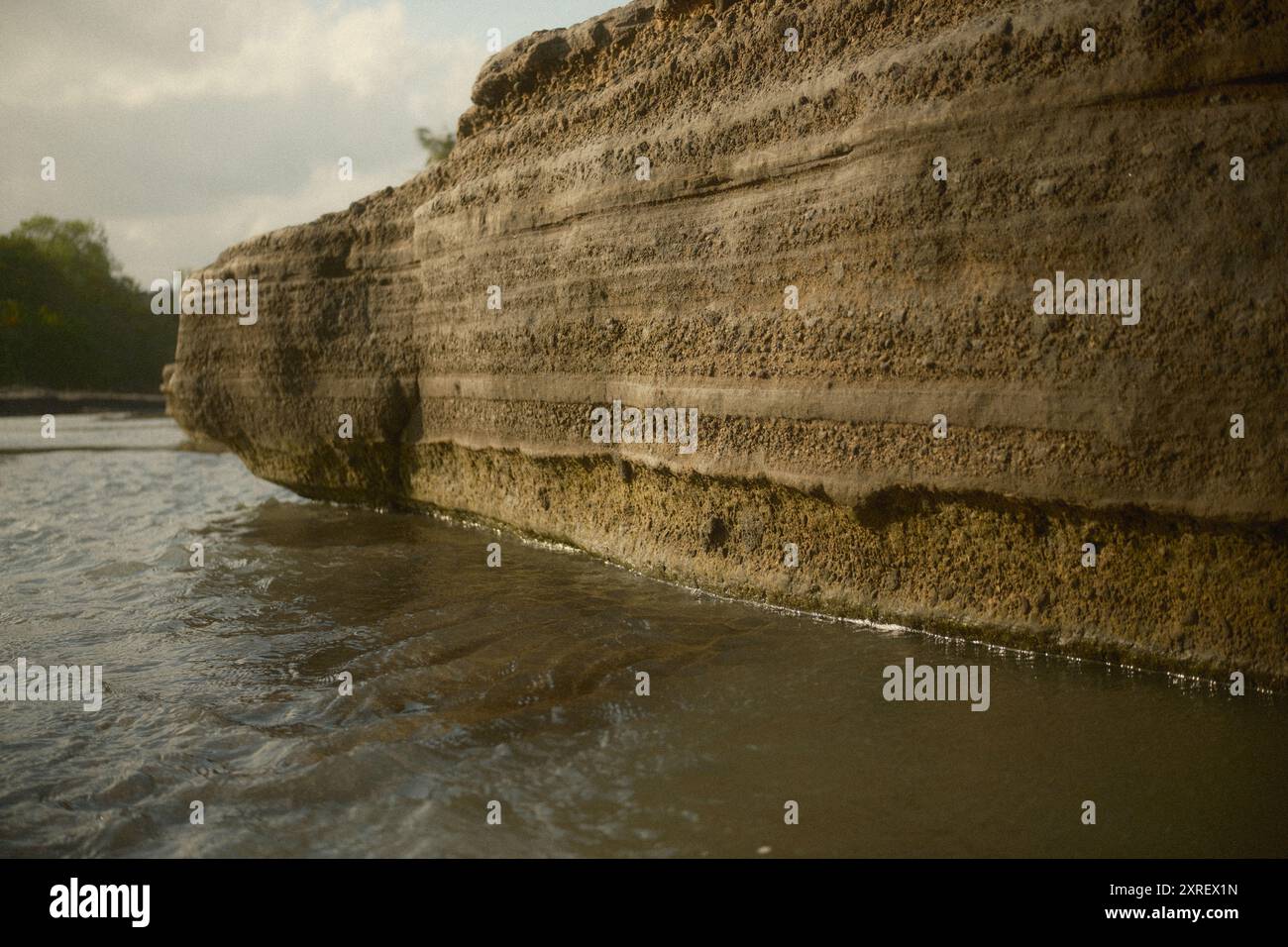 Sedimentary rocks and soil or alluvium along the riverbank, are ...