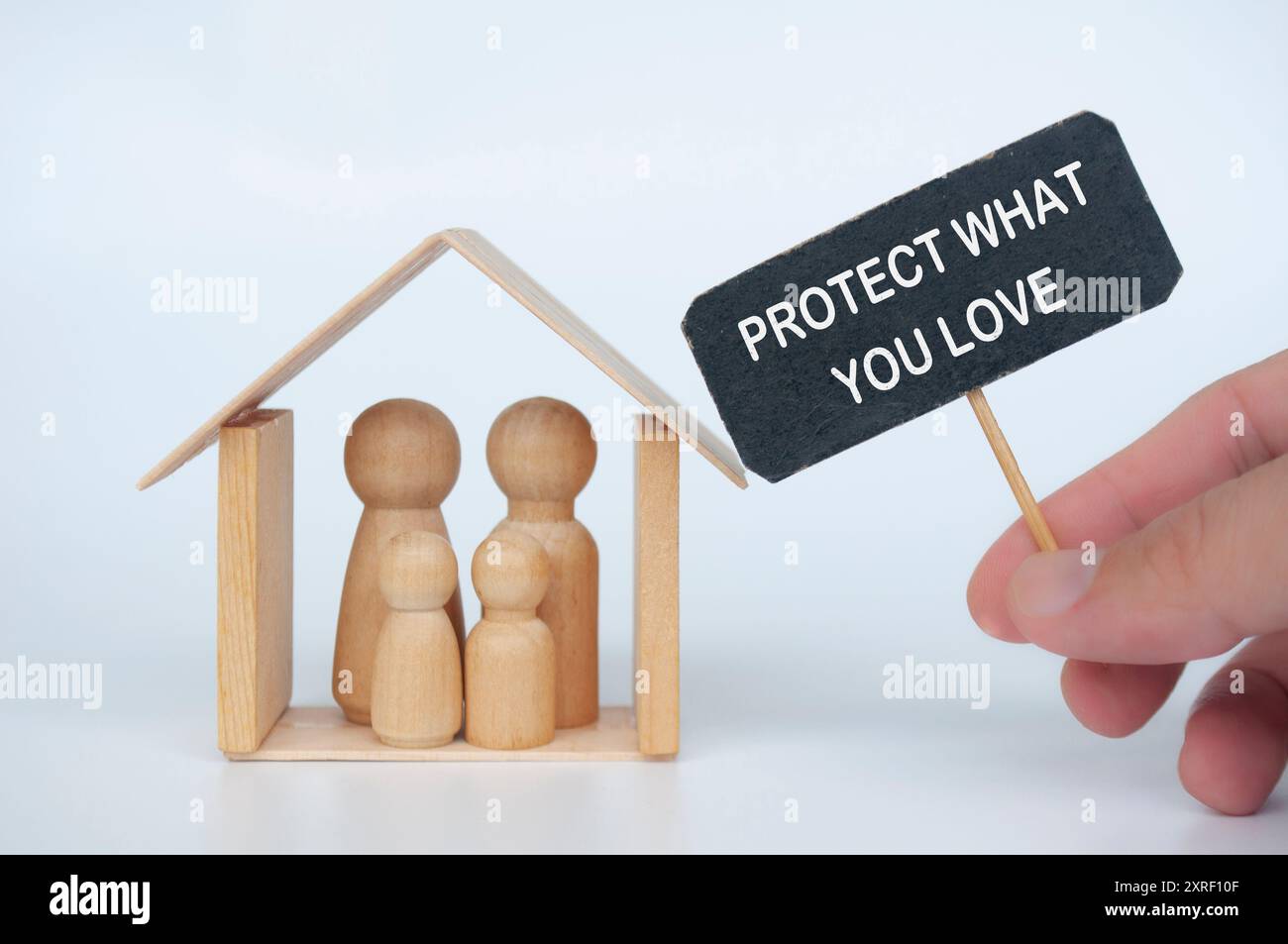 Protect what you love text on black signage with family figure ...