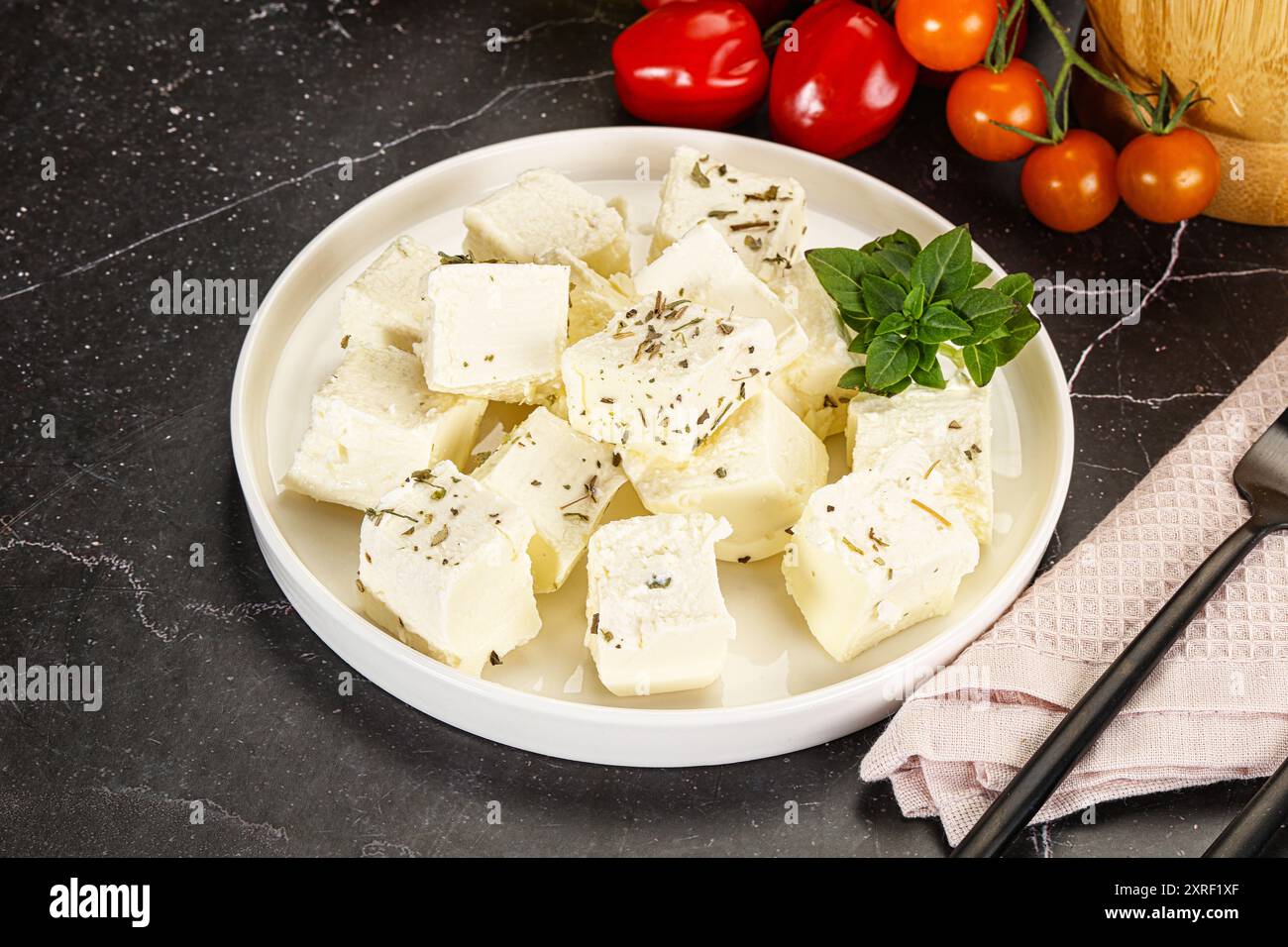 Greek traditional Feta cheese cubes with herbs and spices Stock Photo ...