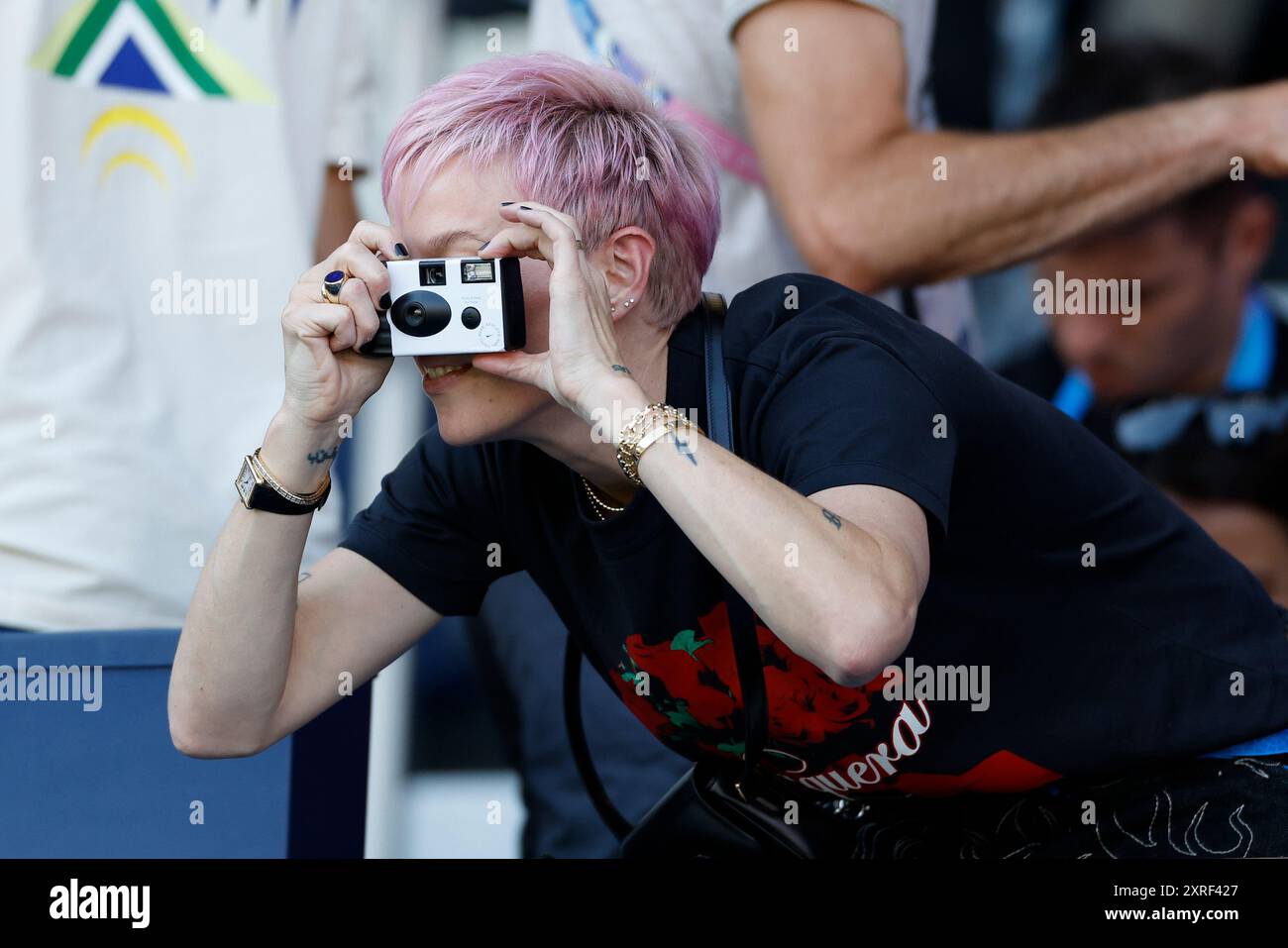Former US soccer player Megan Rapinoe takes photos before the women's ...