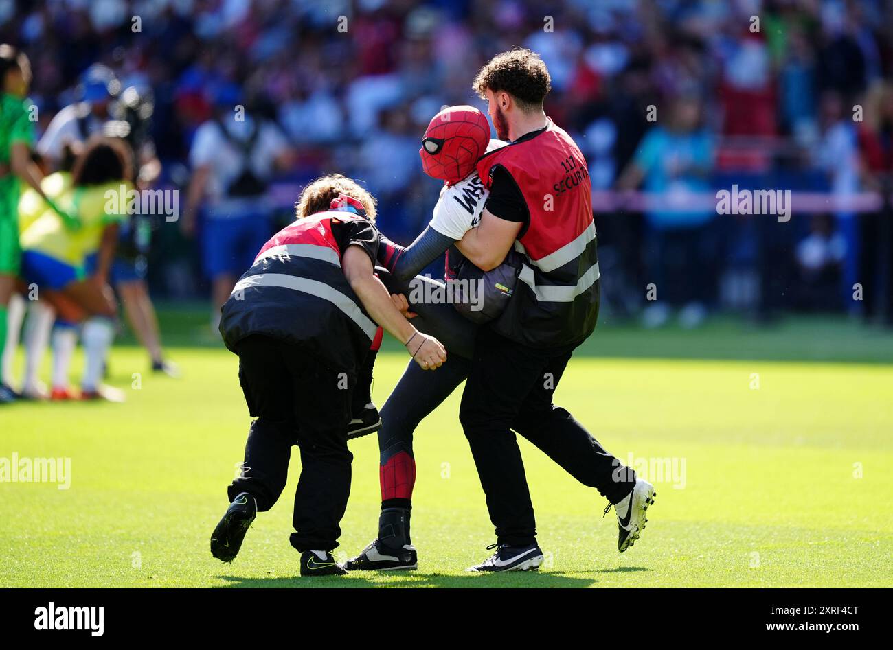 Security staff capture a pitch invader dressed as Spiderman during the ...