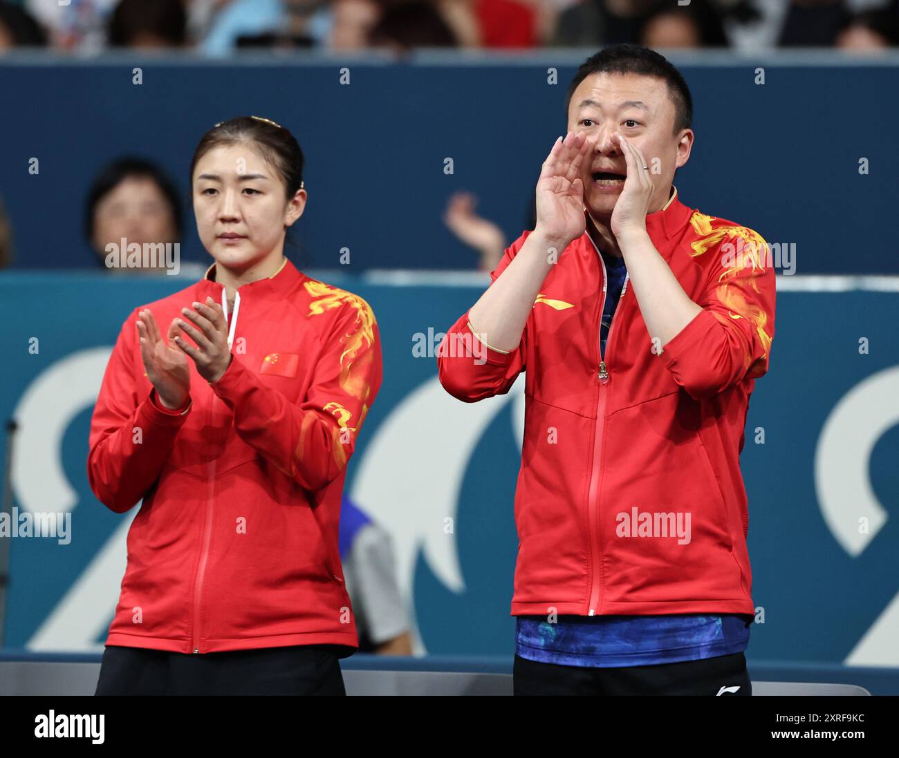 Paris, France. 10th Aug, 2024. Coach Ma Lin (R) and Chen Meng of China ...
