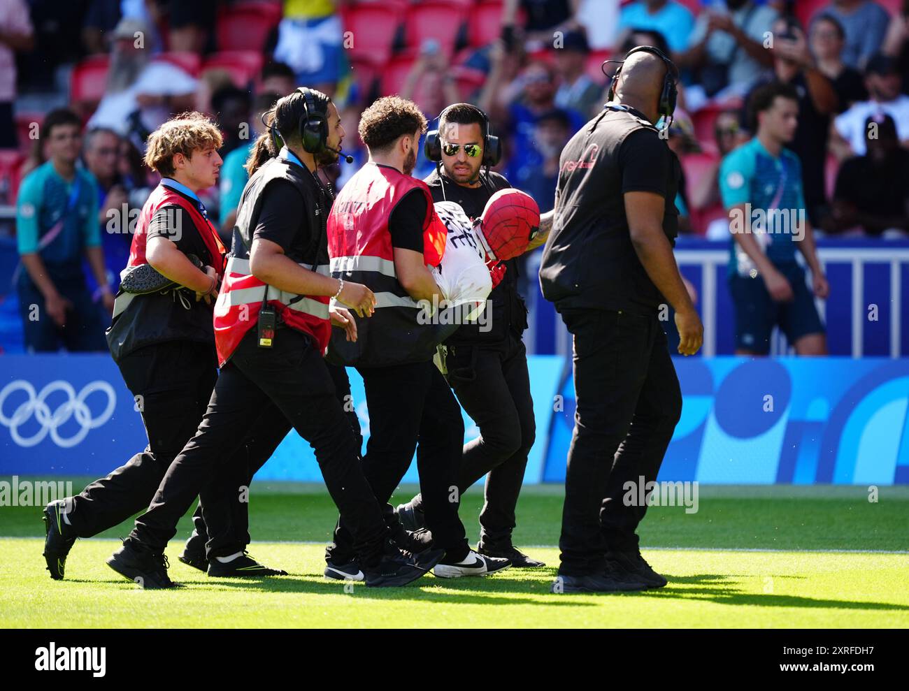 Security staff capture a pitch invader dressed as Spiderman during the ...