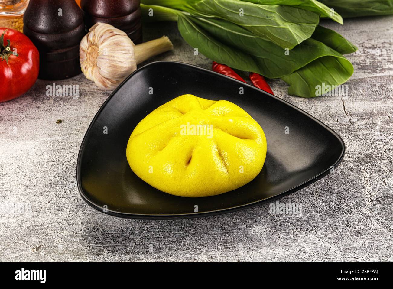 Asian stuffed steamed yellow Bun Bao Stock Photo - Alamy