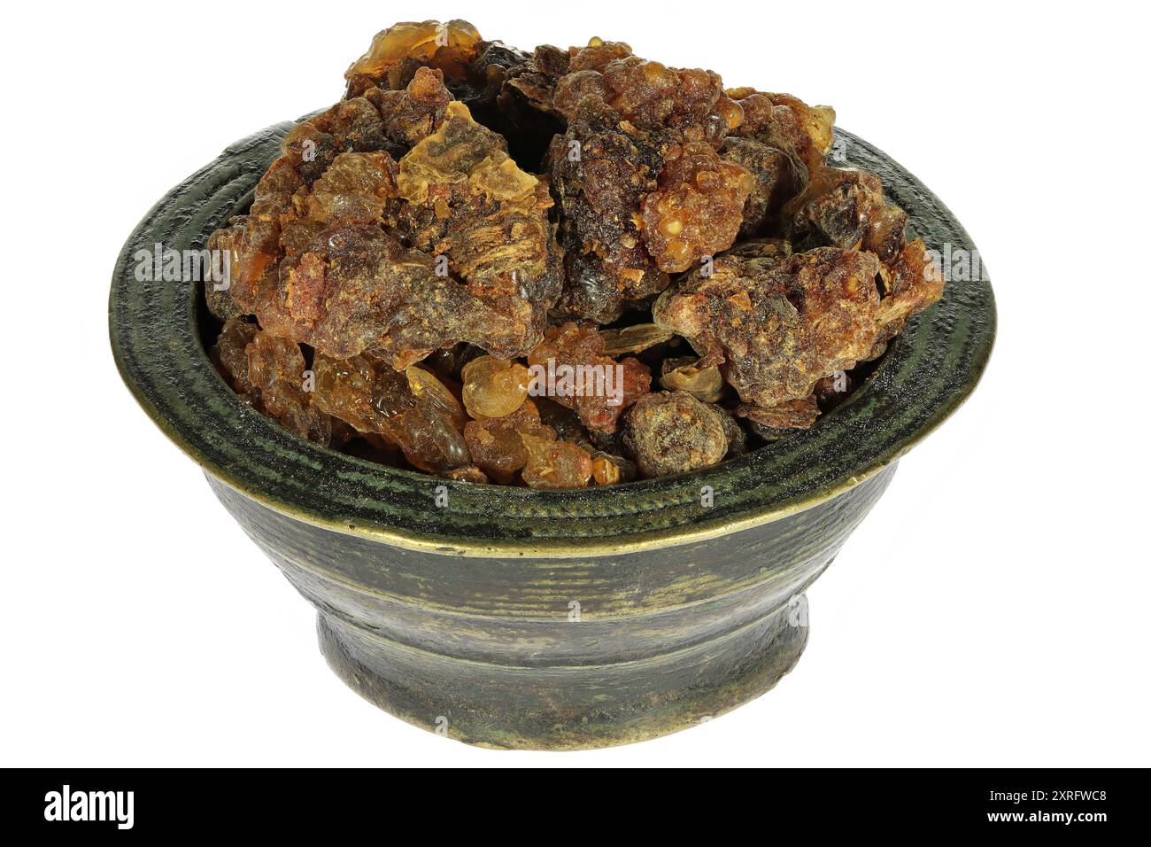 myrrh resin from Oman in a brass bowl isolated on white background ...