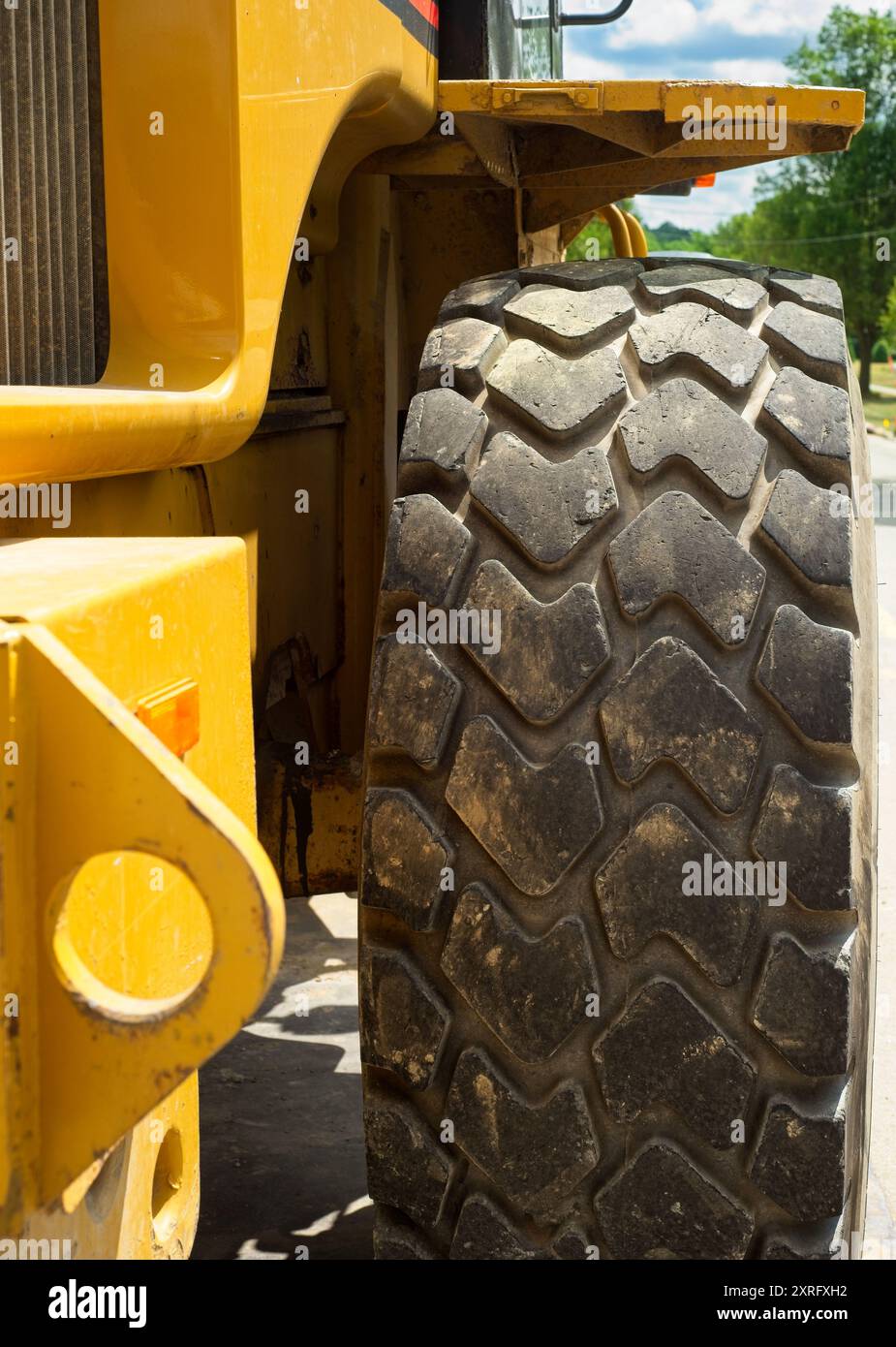 Closeup of an oversize wheel on a front loader in a road construction ...