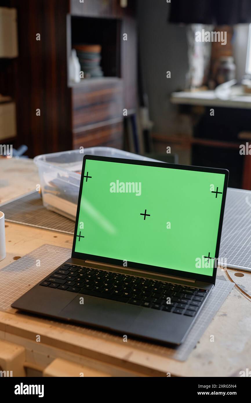 Workspace featuring laptop displaying hi-res stock photography and ...