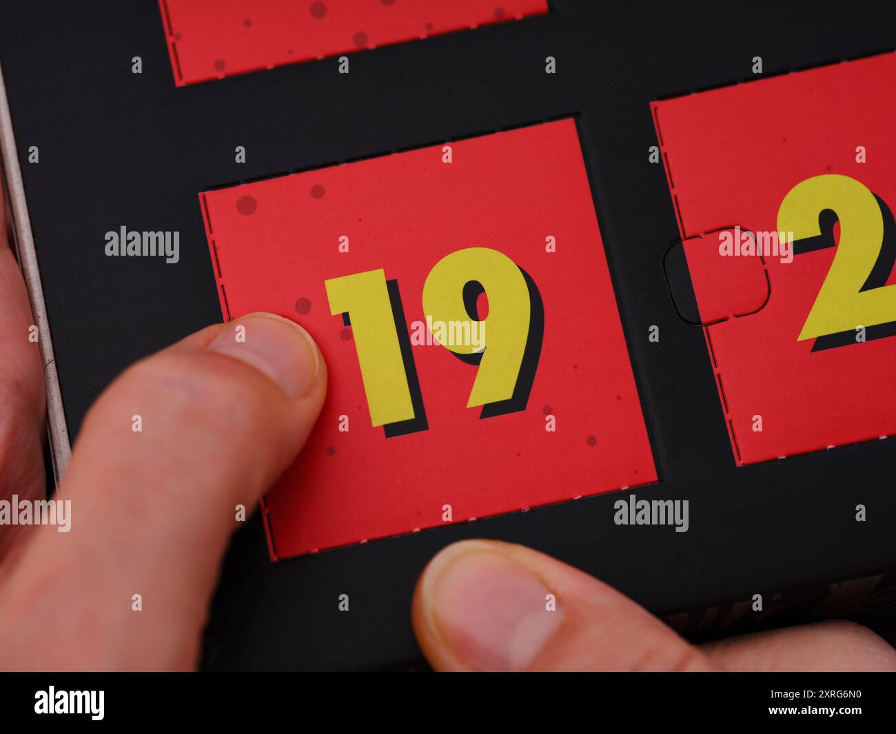 A woman hand ready to open the door with number 19 on the advent ...