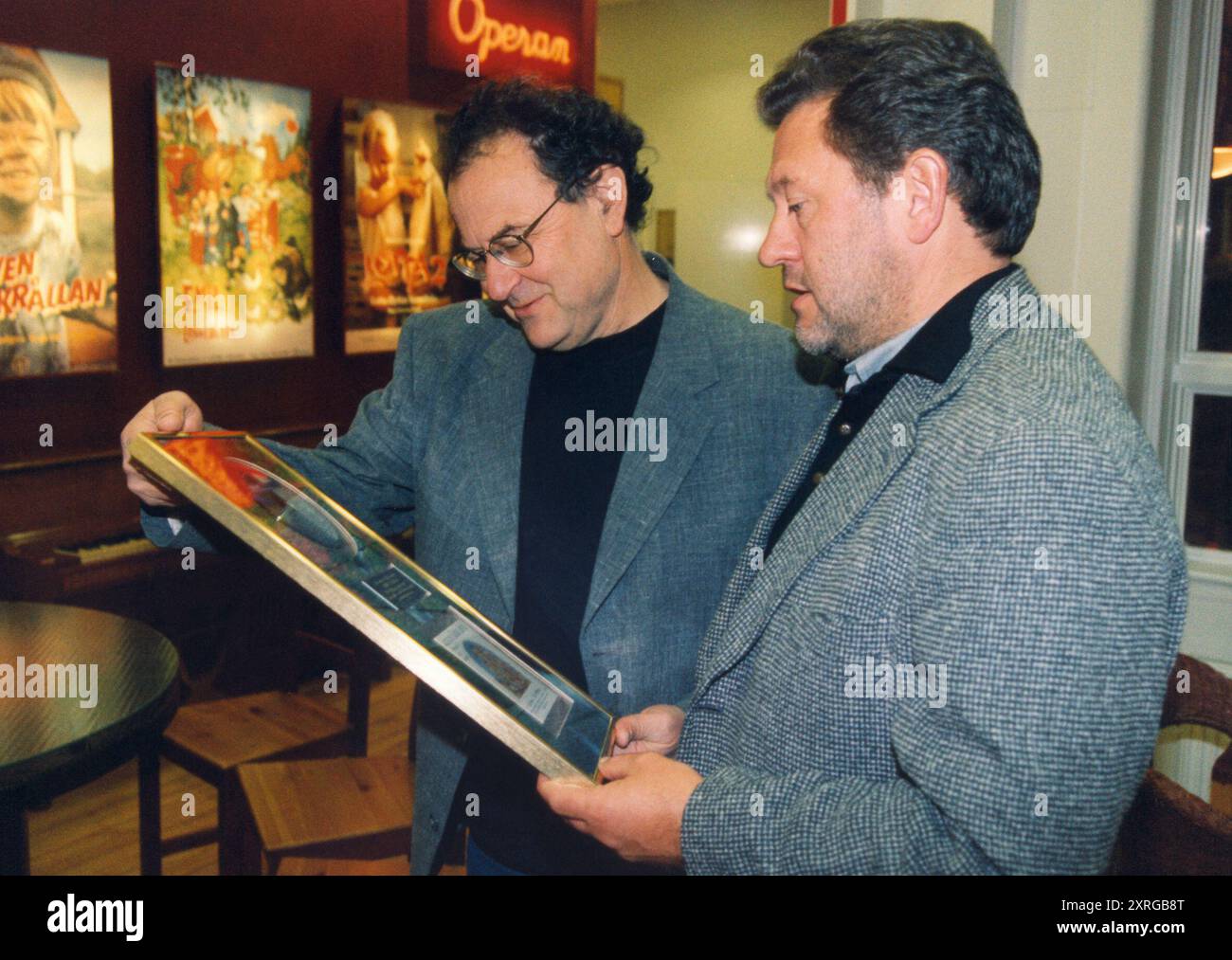 GEORG RIEDEL shows singer Tommy Körberg one of the Gold discs he ...
