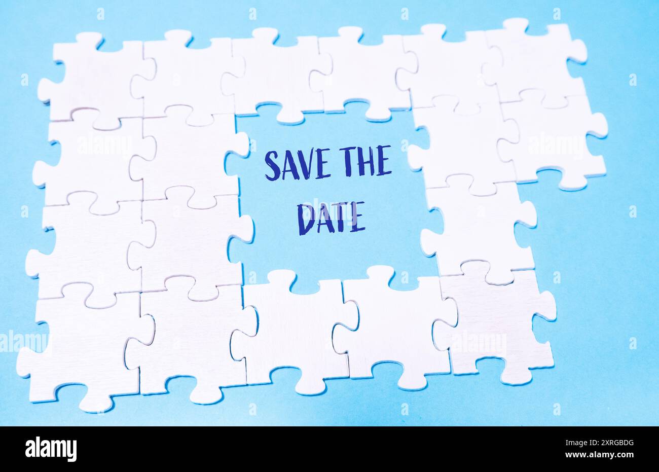 A puzzle with the word save the date written in the middle. The puzzle ...
